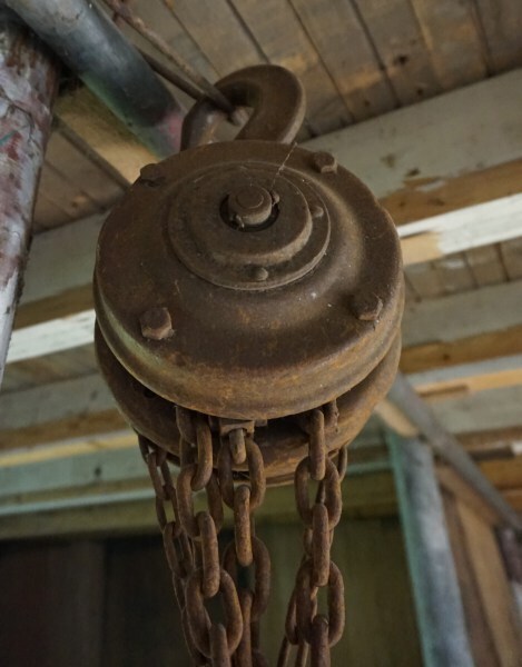 Grote industriele vintage katrol van gietijzer met een lange ketting en ...